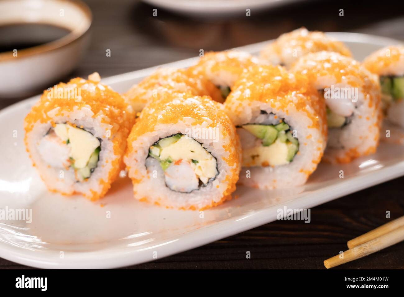 Sushi roll set with shrimp, flying fish reo, avocado and cucumber on a ...