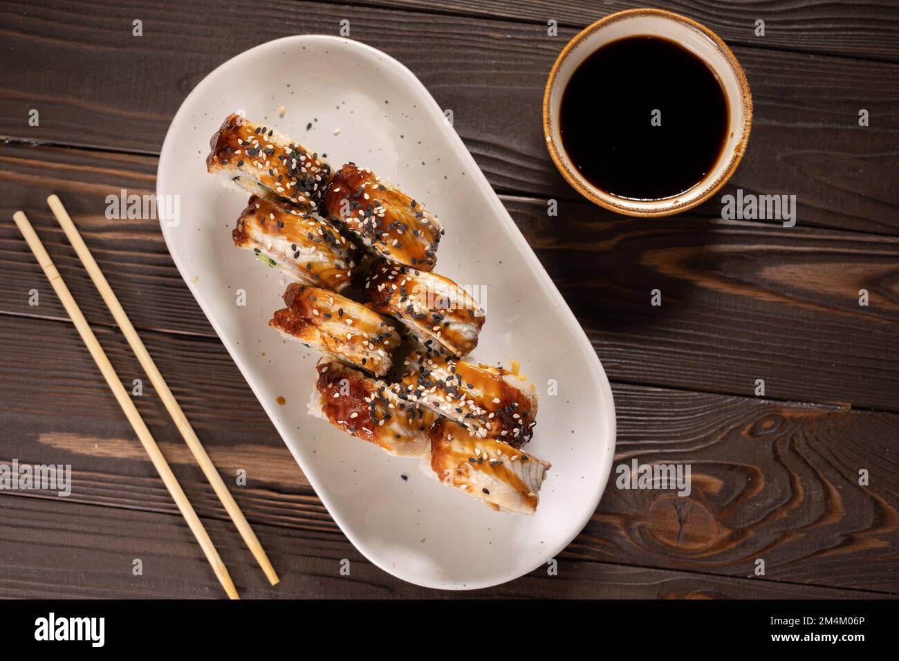 Roll sushi with eel. Canada. On wooden background on a plate with ...