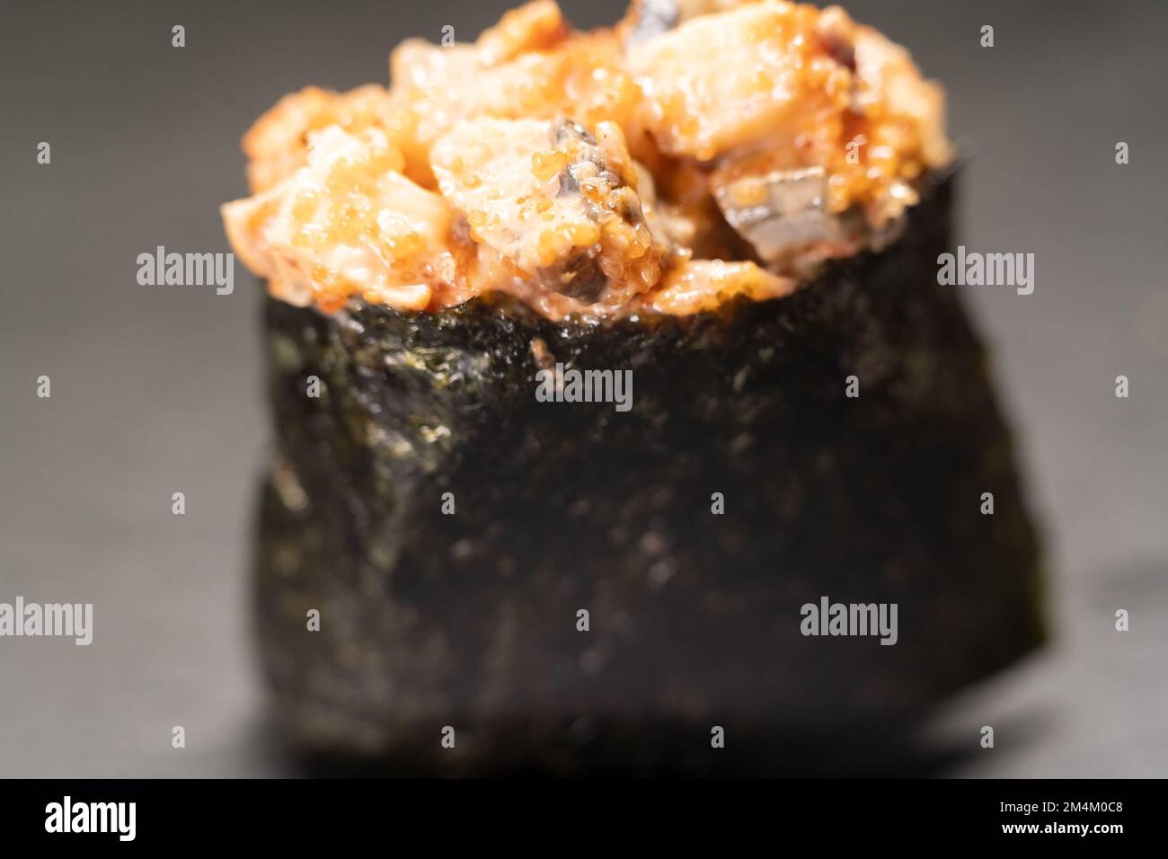 Gunkan Maki Sushi with Seafood and Spicy Sauce isolated on black ...