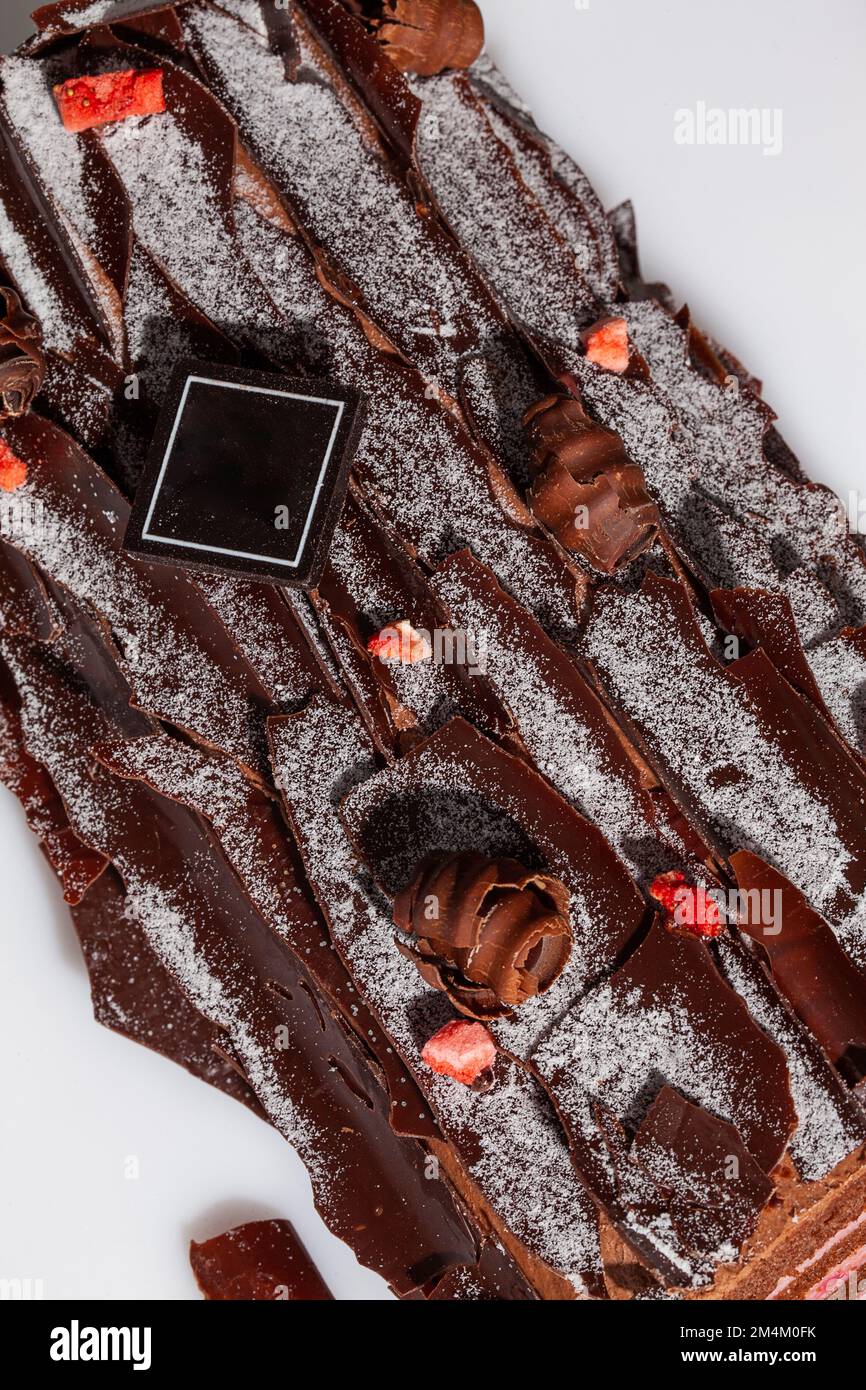 Traditional Yule log with chocolate shavings and candied berries Stock ...