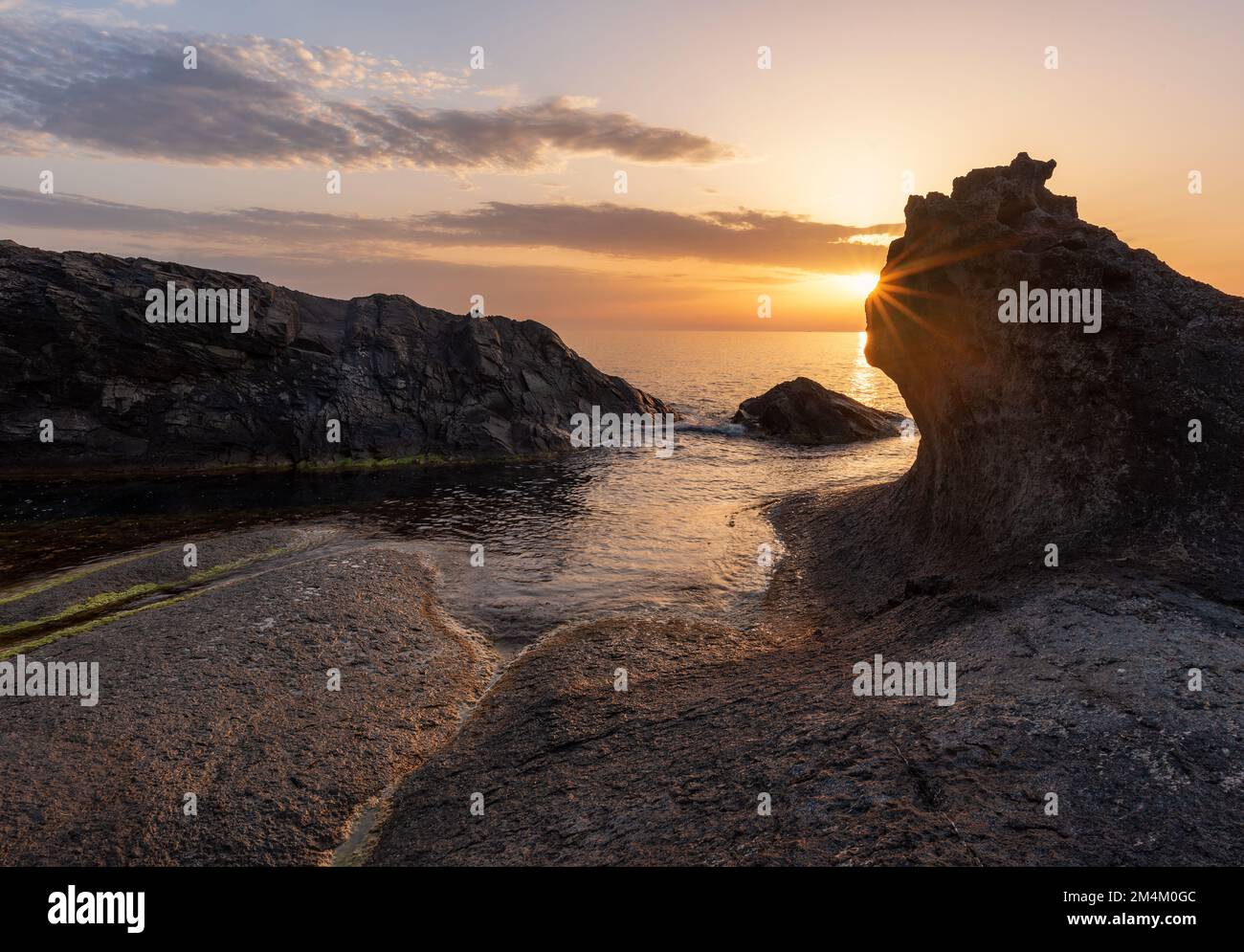 The first sun rays embrace the rocks near Rezovo village, Black sea ...
