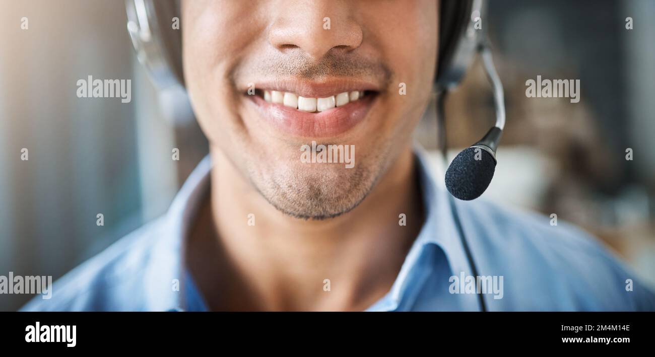 Lets talk. an unrecognizable young man working in a call center Stock ...