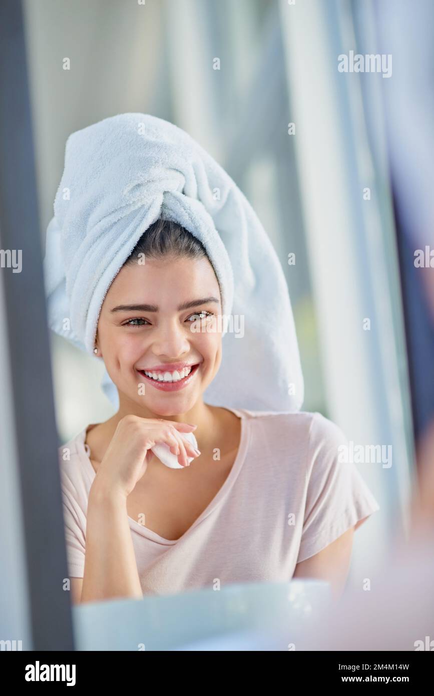 Silky soft skin. a beautiful young woman exfoliating her skin in the ...