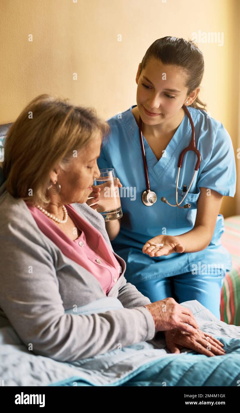 Youll need this...a nurse giving medication and a glass of water to a ...