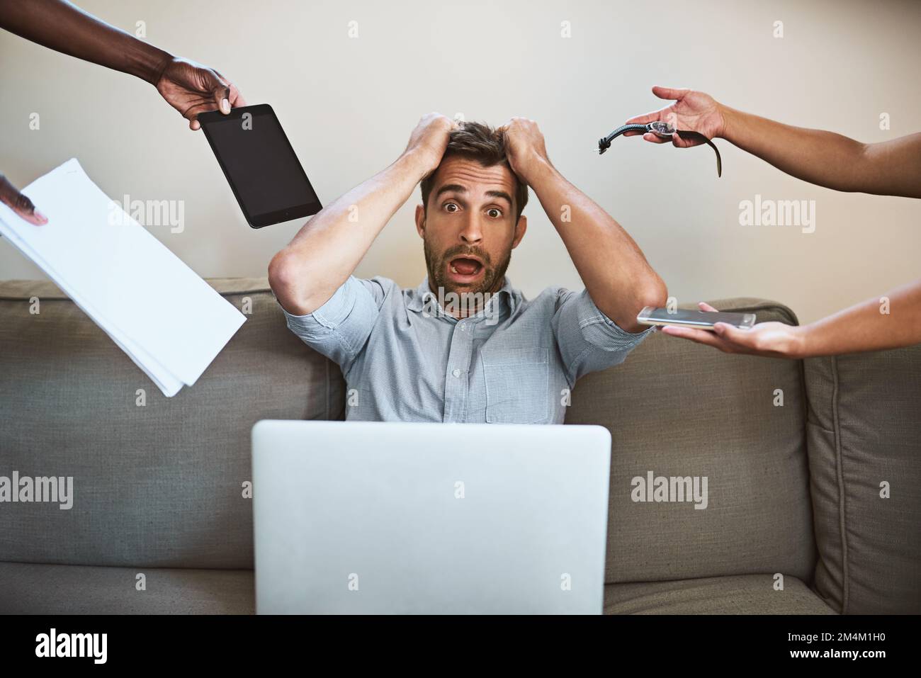 Over worked much. a surprised young businessman being overwhelmed by ...