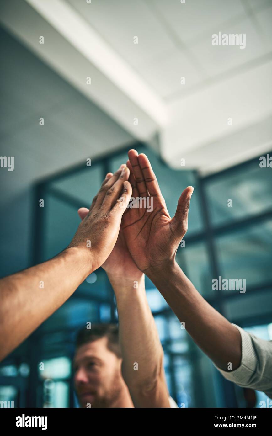 Celebrating an extraordinary team success. Closeup shot of a group of ...