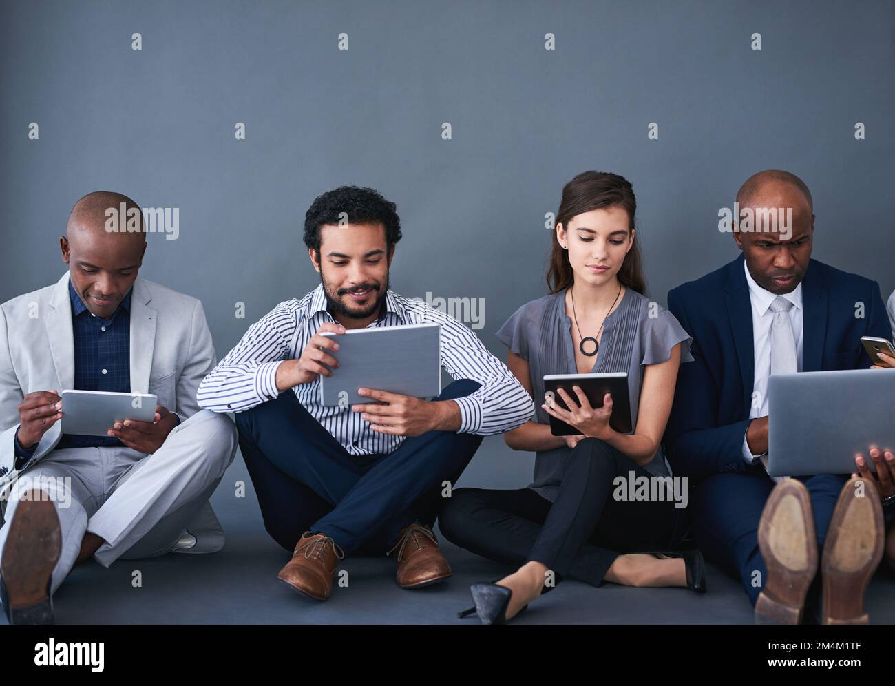 Accessing business information from multiple devices. Studio shot of a ...