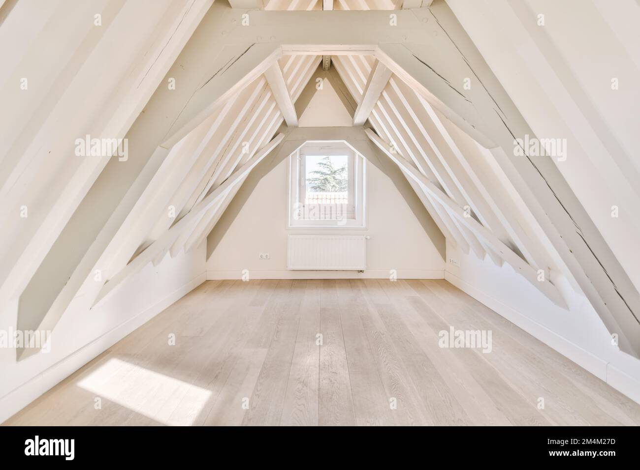 an attic room with white walls and wooden floors, all painted in the ...