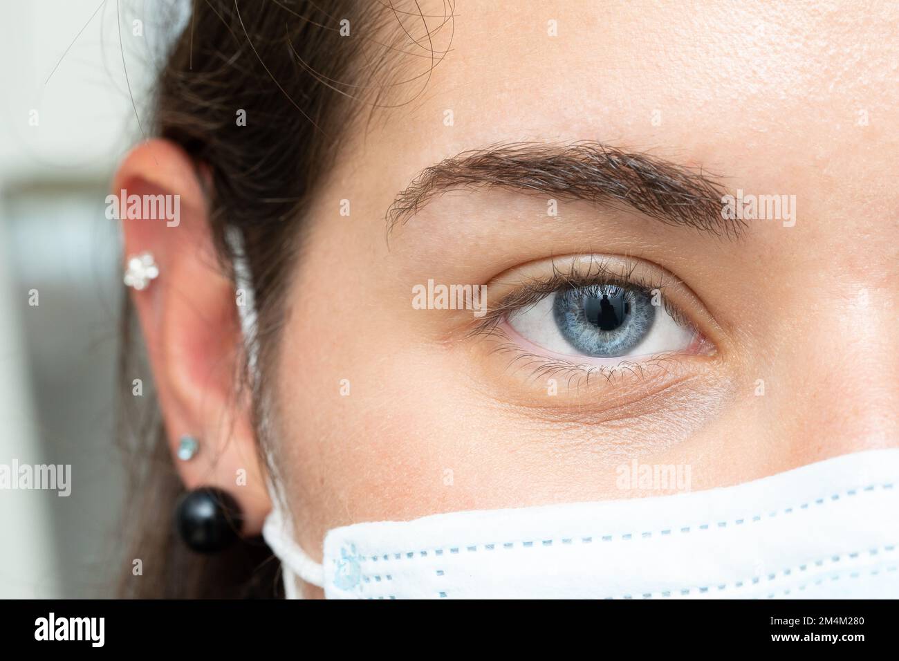 Alluring look of an intense blue female eye. Manicured eyebrows and ...