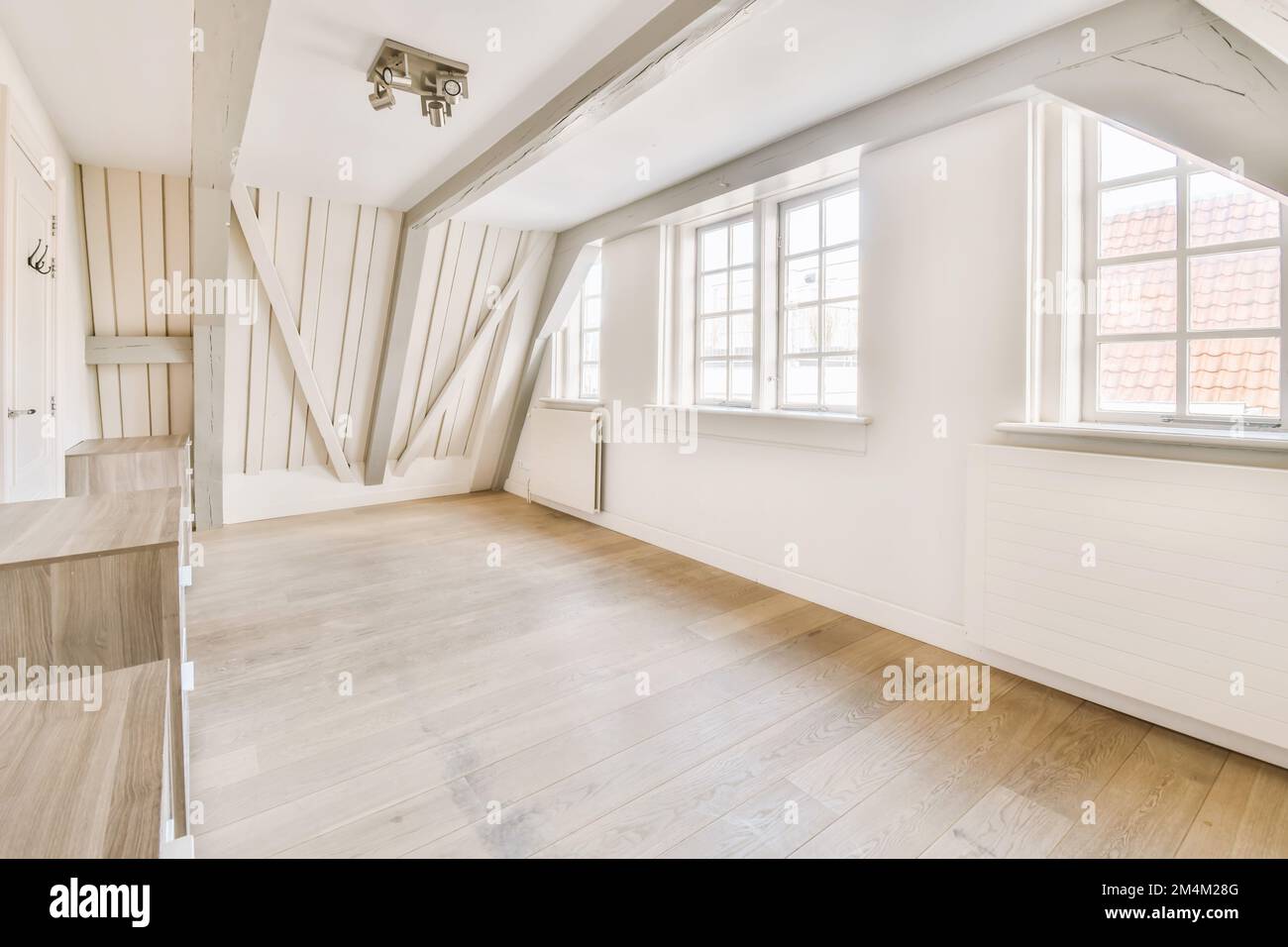 an empty room with wood flooring and white paint on the walls there is ...