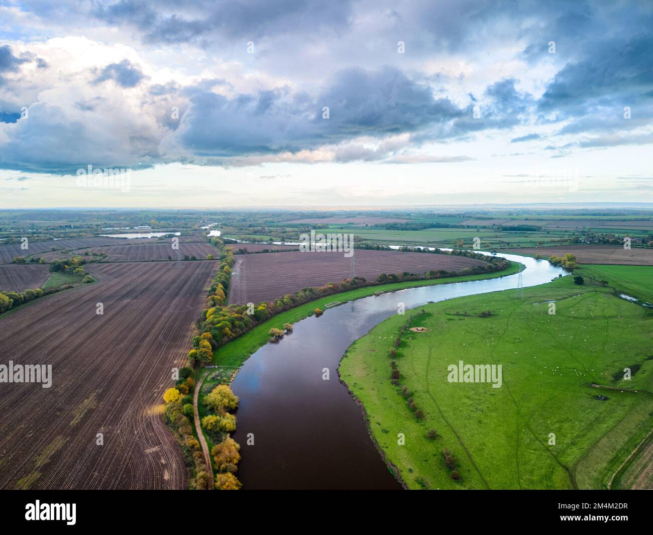 An aerial view of a river surrounded by agricultural lands in a rural ...