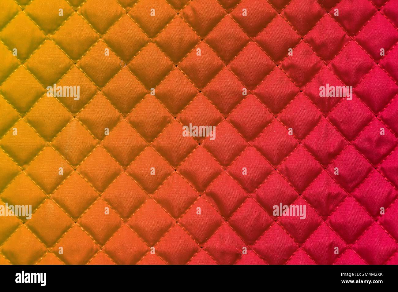 red stitched quilted bag cloth background closeup Stock Photo - Alamy