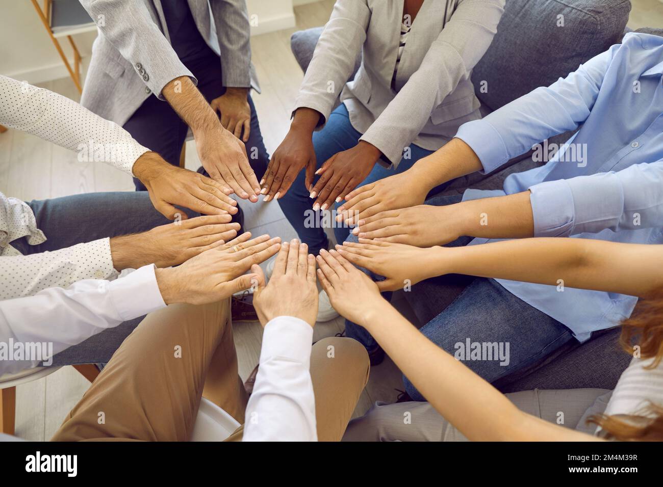 Different multiracial men and women form circle with their hands ...