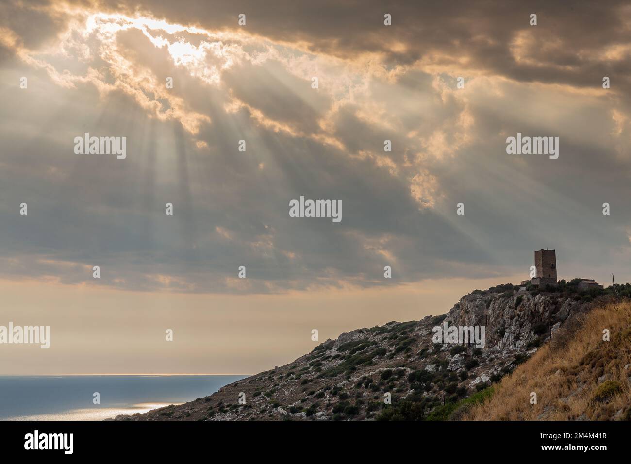 Landscape at sunset with the sun filtering through the clouds of a ...