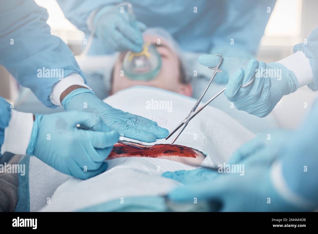 Hands, blood and operation with a team of doctors at work during ...
