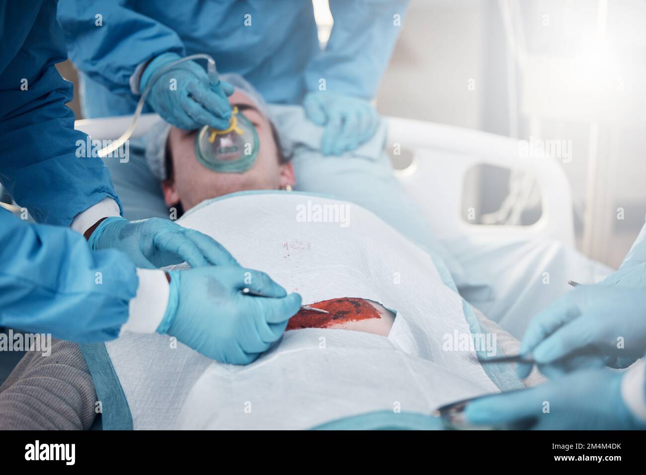 Doctors, surgery and blood with a medicine team in scrubs operating on ...