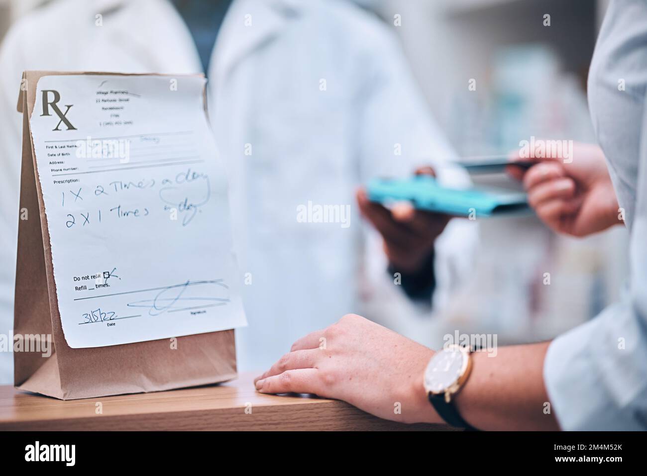 Pharmacy, card machine and patient paying for the medication at medical ...