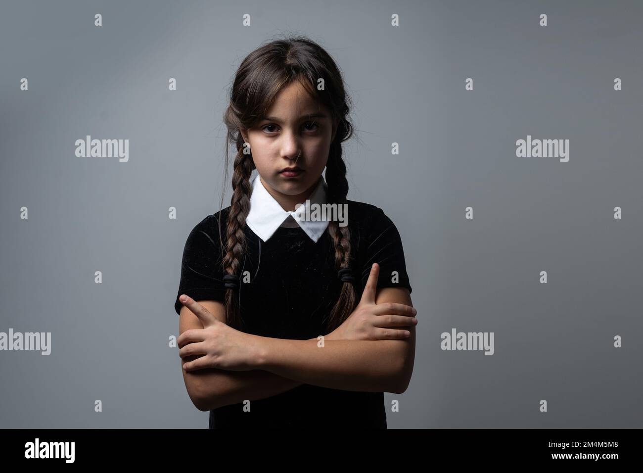 Portrait of little girl with Wednesday Addams costume during Halloween ...