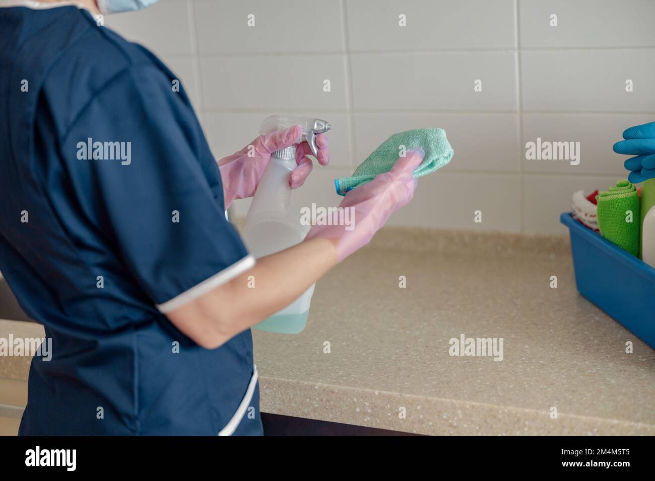 Cleaning lady washing tile with detergent and rag on kitchen. Hygiene ...