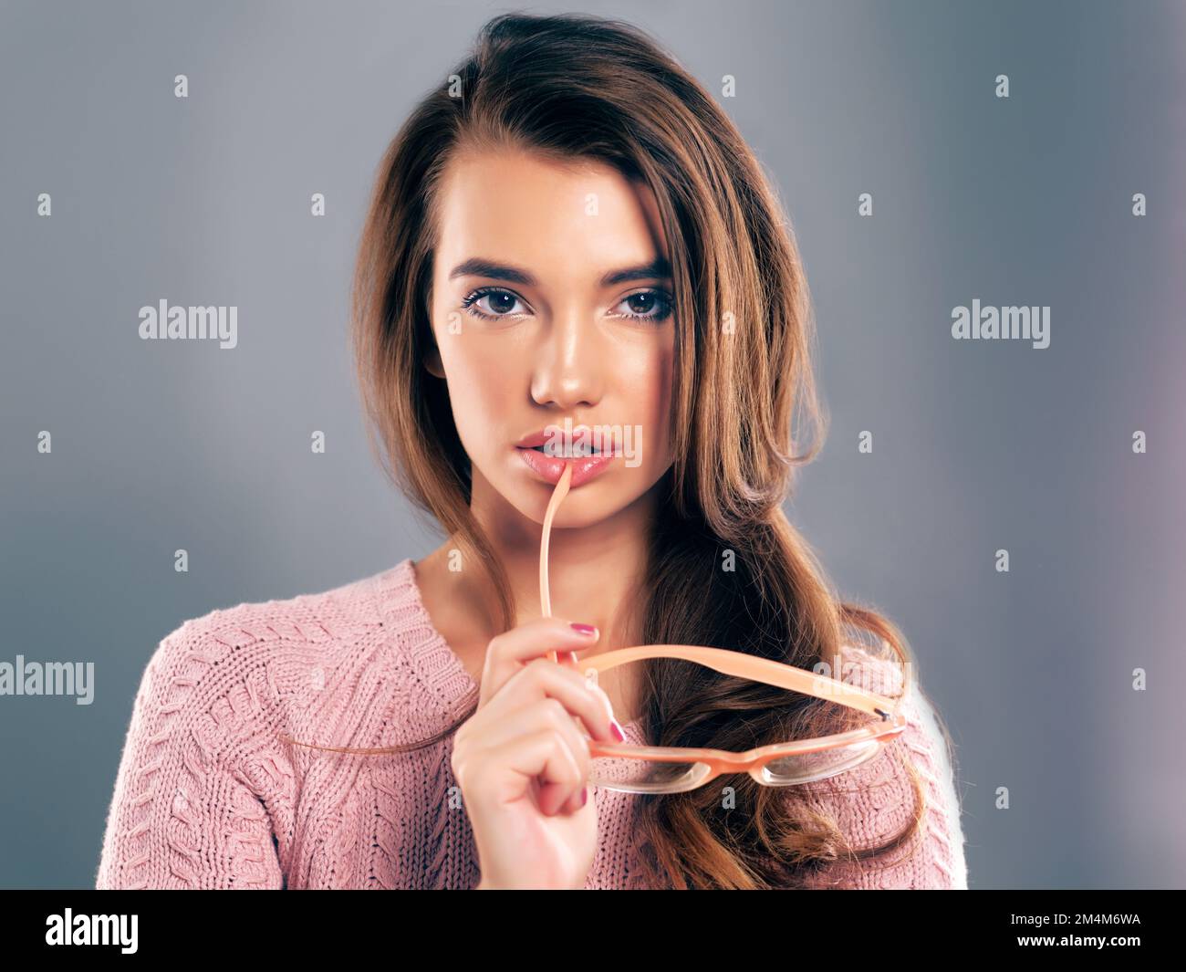 Stunning even without her glasses. Studio shot of a beautiful young ...