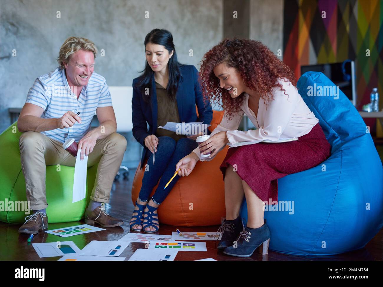 Its time to narrow down our ideas. a group of creative workers having a ...