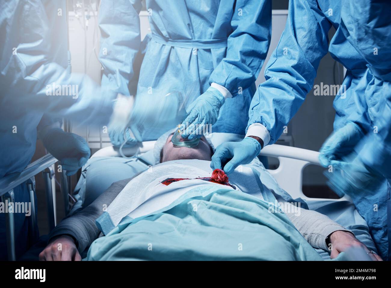 Doctors, surgery and blood with a medicine team in scrubs operating on ...