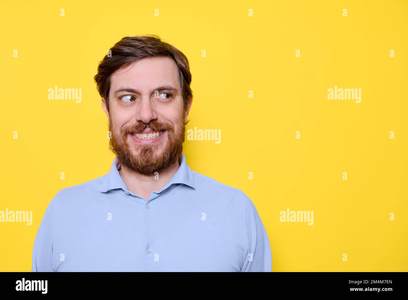 Smart bearded man face expression on yellow background Stock Photo - Alamy