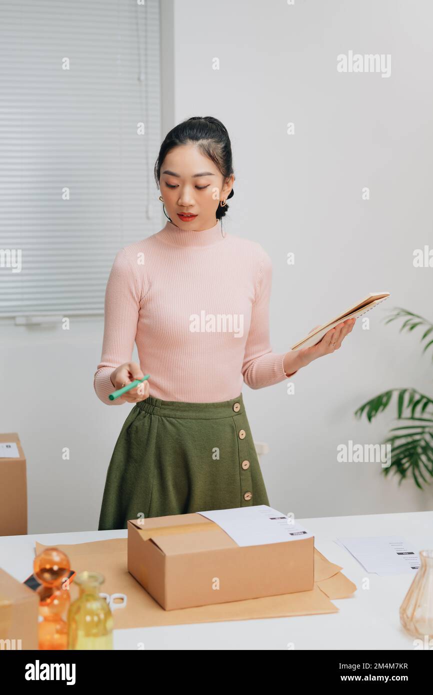 female online store small business owner seller entrepreneur packing ...