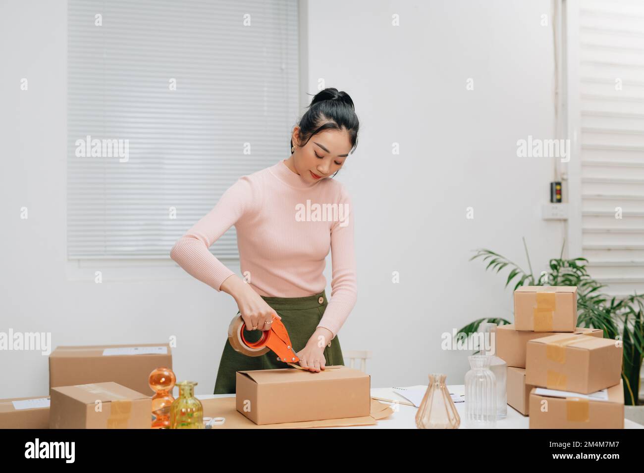 Small business owners are packing cardboard boxes at work Stock Photo ...