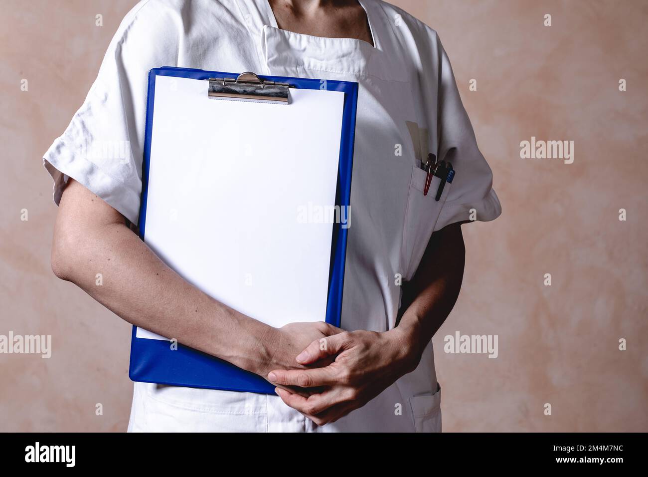 Unrecognizable nurse with an empty report folder waiting for a patient ...