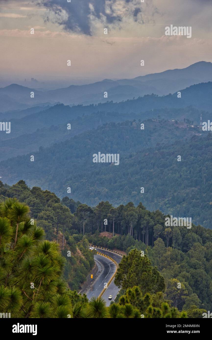 A vertical shot of the Murree Expressway on the mountain covered in ...