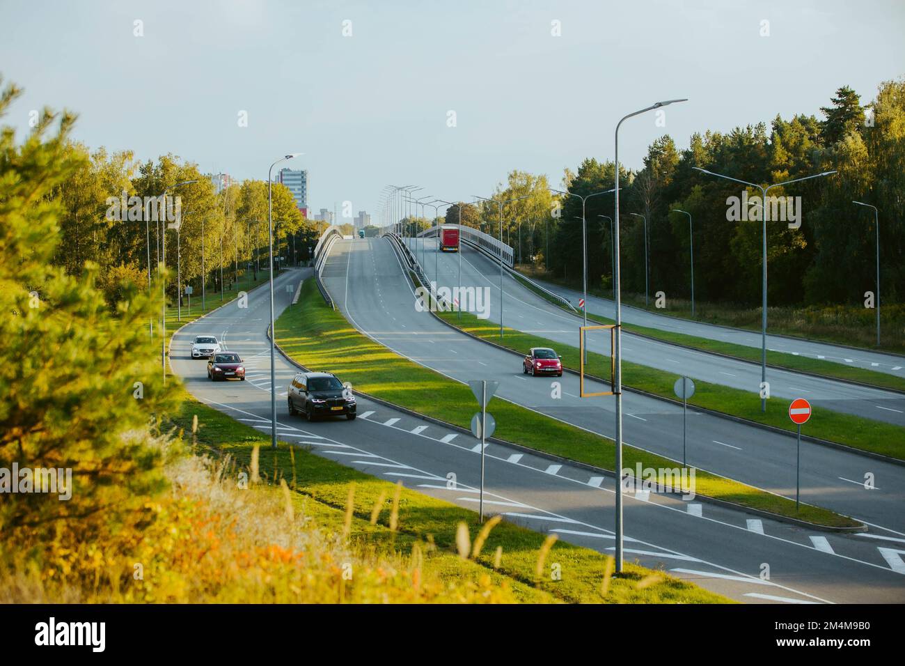 A top view of cars driving along a highway road in the evening time ...
