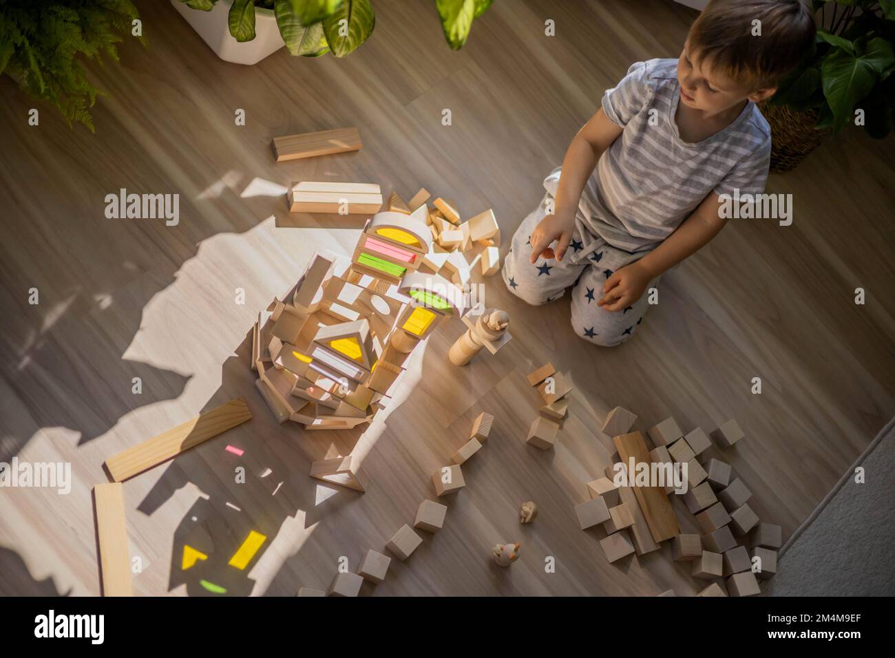 Cute baby boy building tower wooden bricks Montessori materials at ...