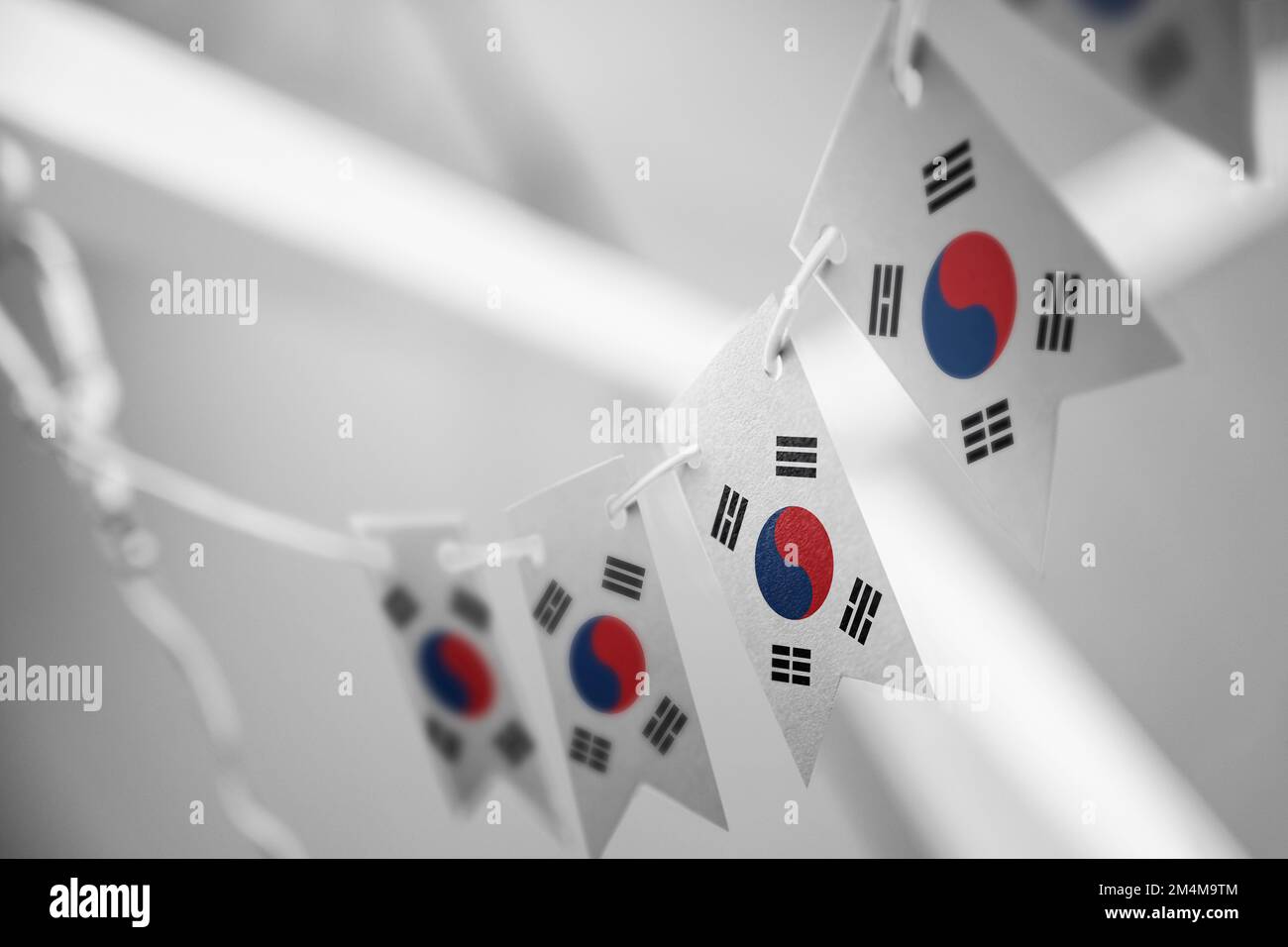 A garland of South Korean national flags on an abstract blurred ...