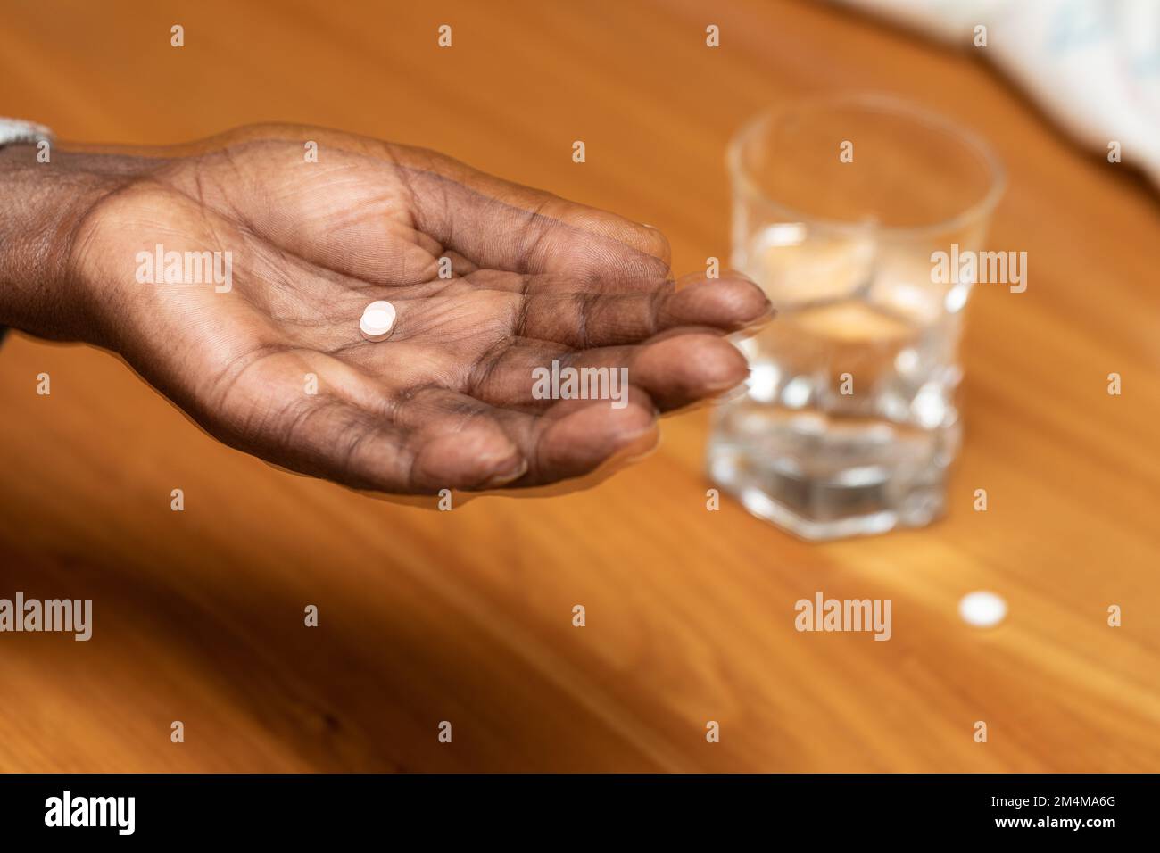 Closeup of an African woman hand with a pill. Concept of dangerous ...