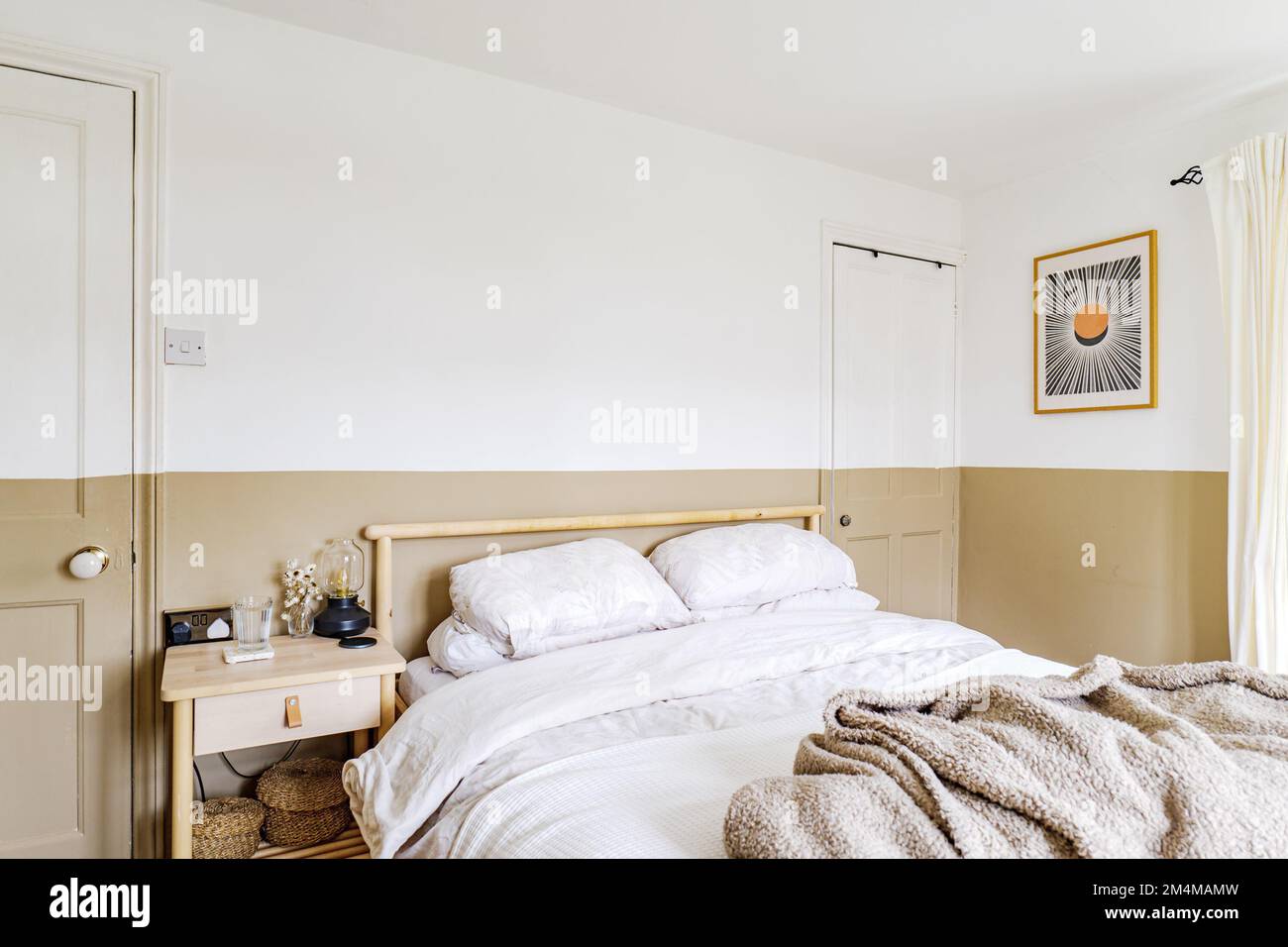 A cosy, well decorated, light and airy bedroom. Bed with throw and ...