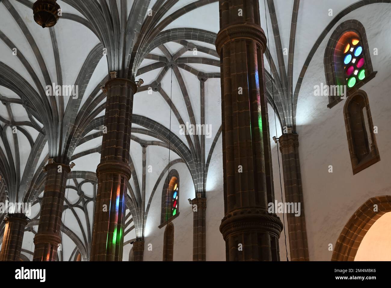 The interior of an arched building with columns and small windows Stock ...