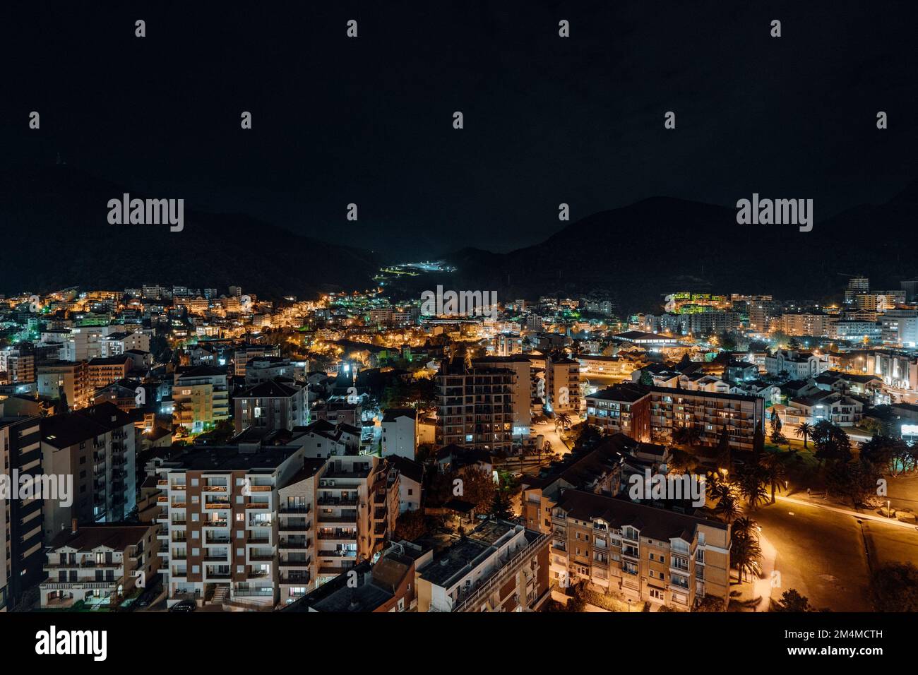 An aerial view of the cityscape of Budva at night, Montenegro Stock ...