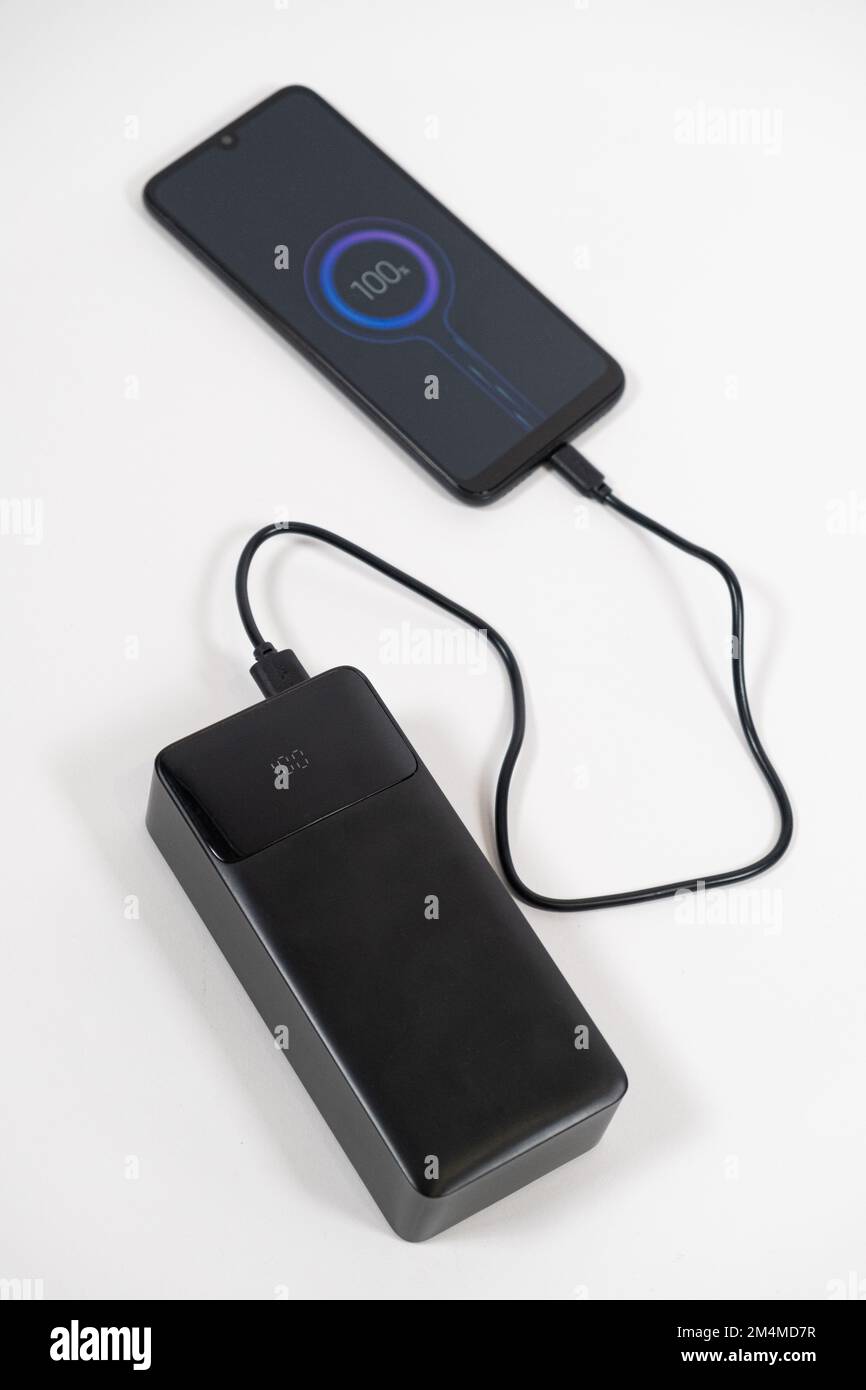 Connecting a mobile phone to a power bank. Charging gadgets from power ...