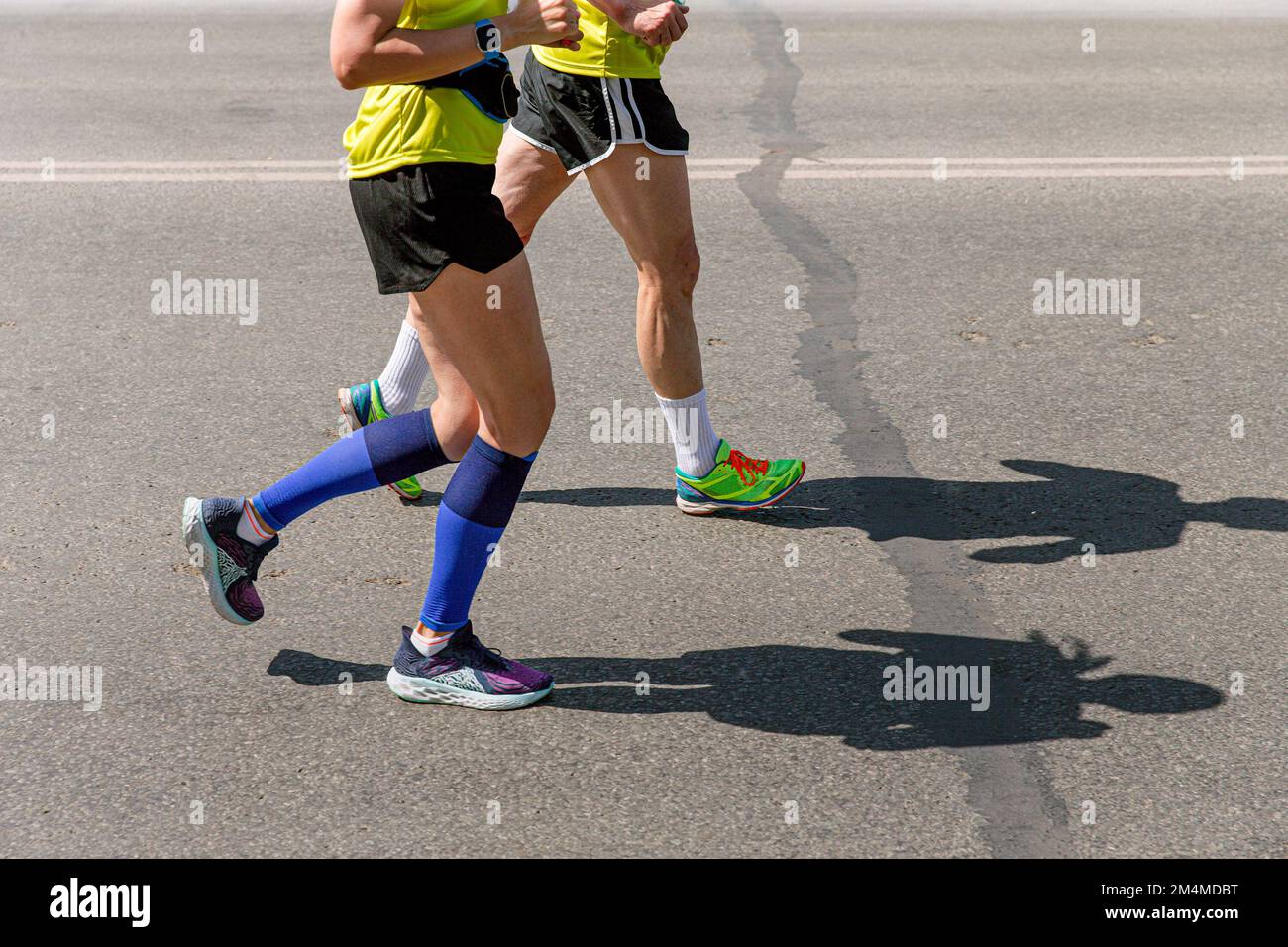 legs man and woman runners run marathon street Stock Photo - Alamy