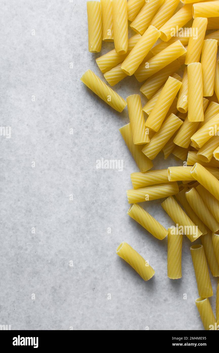 Flat lat of uncooked tortiglioni pasta shells, top view of tortiglioni ...