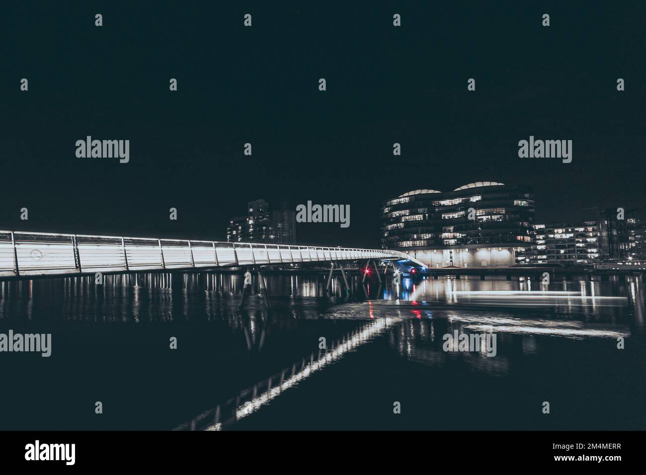 illuminated footbridge over the water at night Stock Photo - Alamy