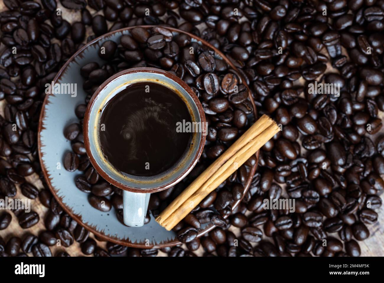 a cup of coffee with roasted coffee beans on a wooden background Stock ...