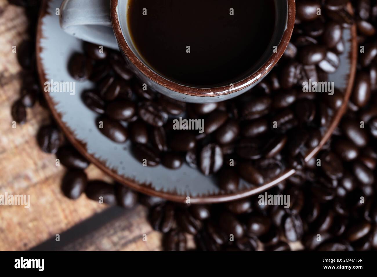 a cup of coffee with roasted coffee beans on a wooden background Stock ...