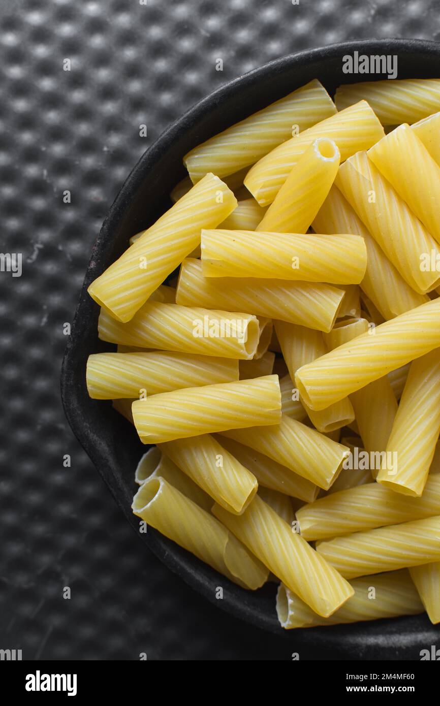 Flat lay of uncooked tortiglioni pasta shells, top view of tortiglioni ...