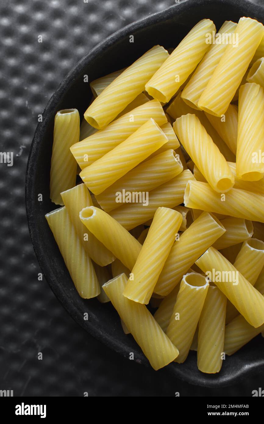 Flat lay of uncooked tortiglioni pasta shells, top view of tortiglioni ...