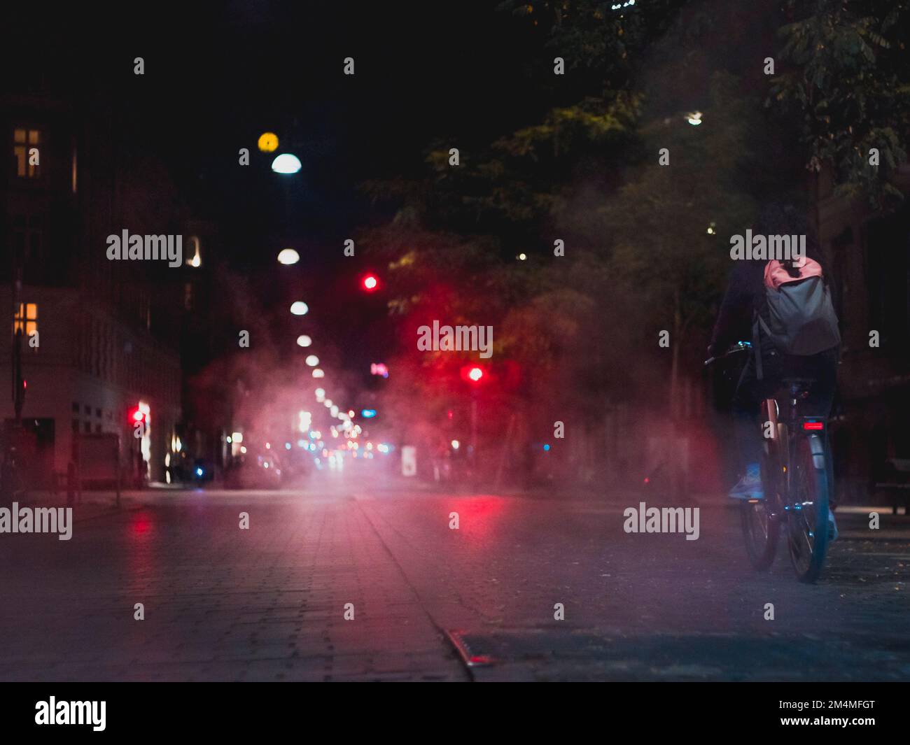cyclists on the night city street, colorful steam at night Stock Photo ...