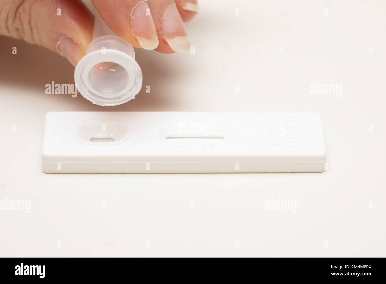 Macro of a woman's hand who is pouring solvent from a homemade quick ...