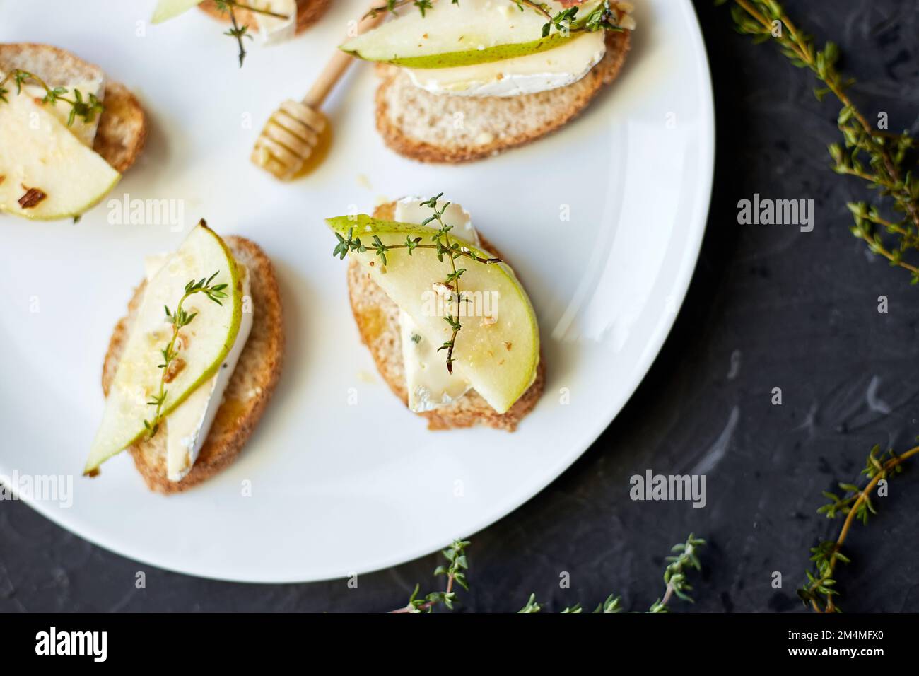 Sandwich or bruschetta with pear and blue cheese on white plate on ...