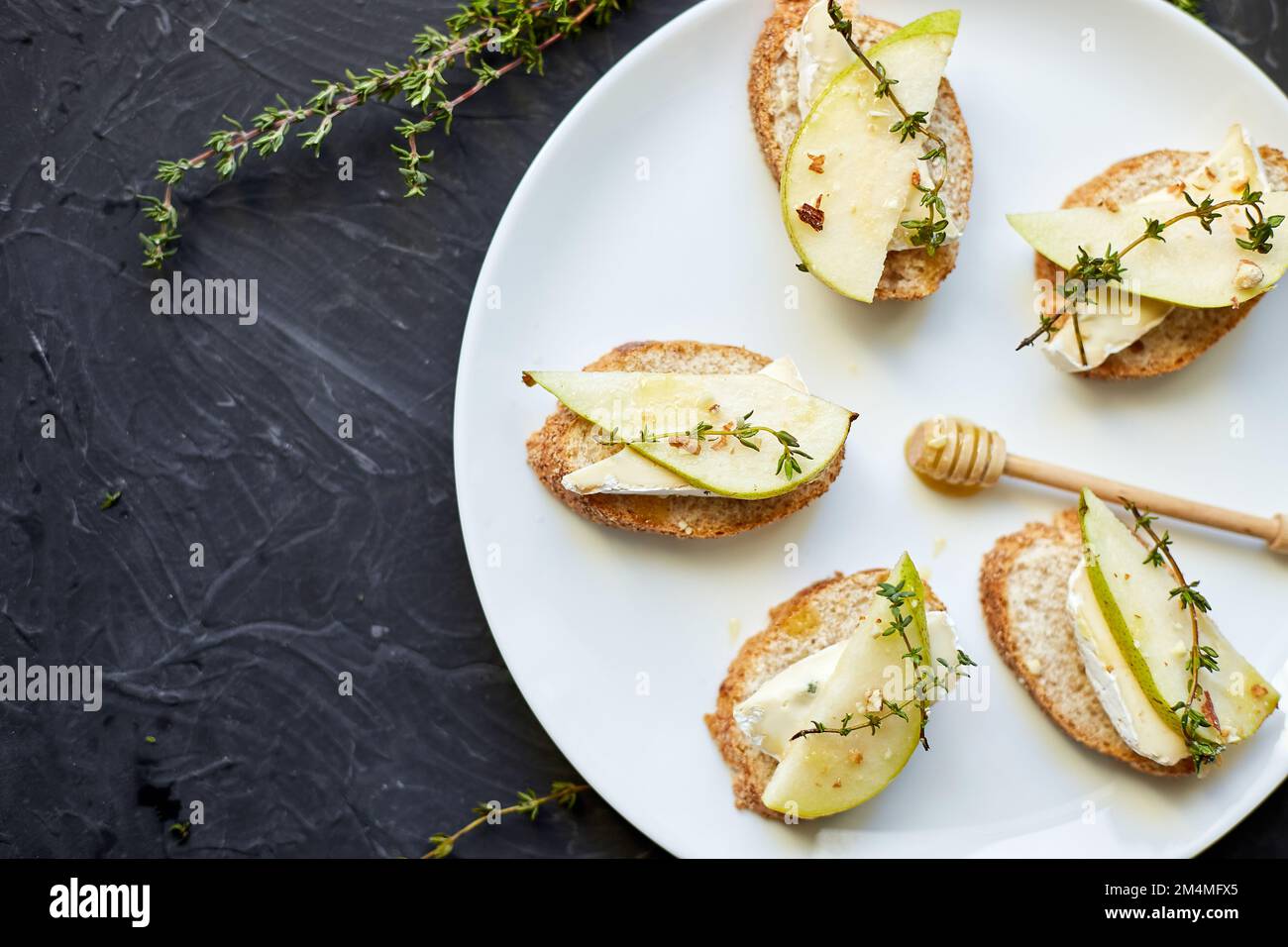 Sandwich or bruschetta with pear and blue cheese on white plate on ...